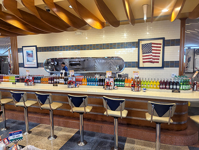The counter seating offers front-row tickets to the culinary show, with colorful bottles standing at attention like soldiers of satisfaction.