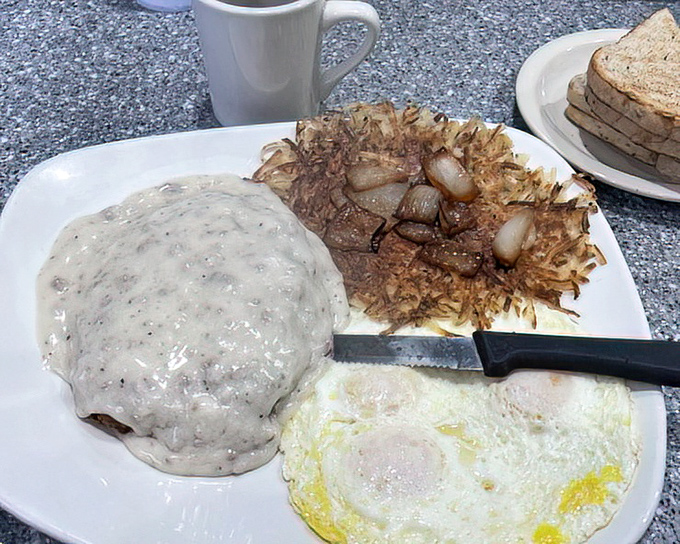 Country fried steak with gravy, eggs, and hashbrowns—the breakfast trifecta that turns morning skeptics into devoted disciples.