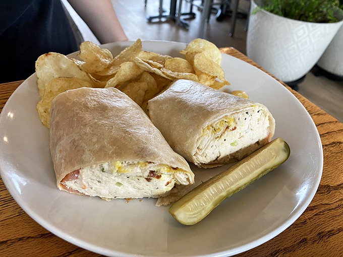 This wrap means business—stuffed with what looks like chicken salad and served with house-made chips and a pickle spear for moral support.