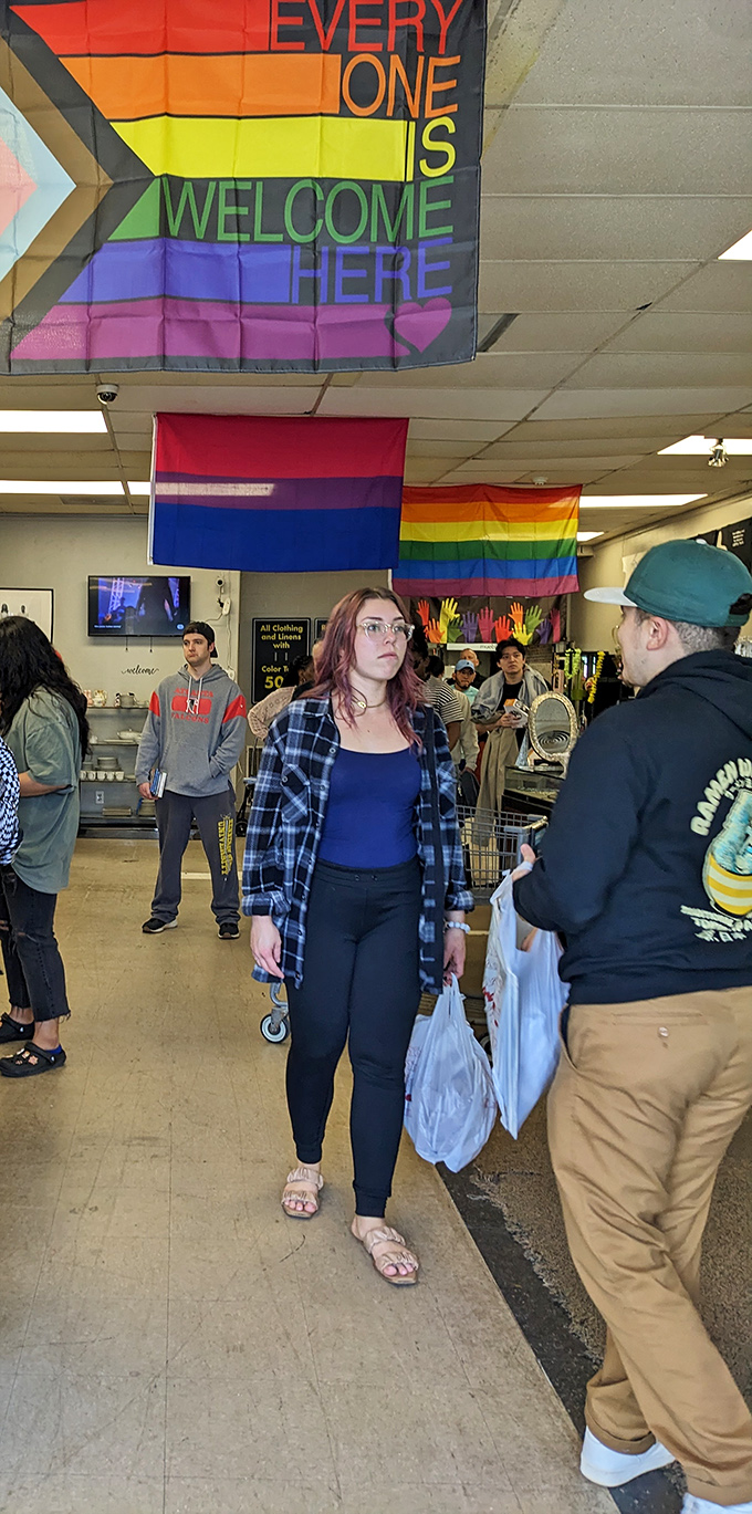 Rainbow flags declare "Everyone Is Welcome Here"—a shopping experience where both your budget and your authentic self can breathe easy.