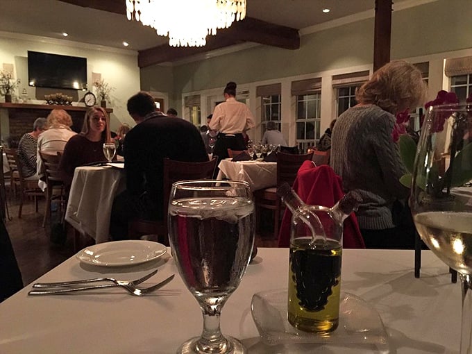 The gentle hum of satisfied diners creates the perfect soundtrack for an evening of exceptional food and wine in this intimate setting.