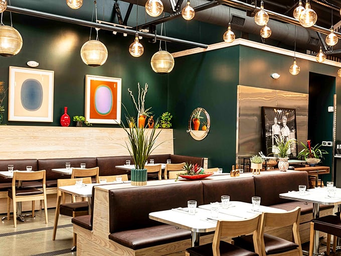 Deep green walls and pendant lighting create the perfect backdrop for food that deserves its own spotlight.