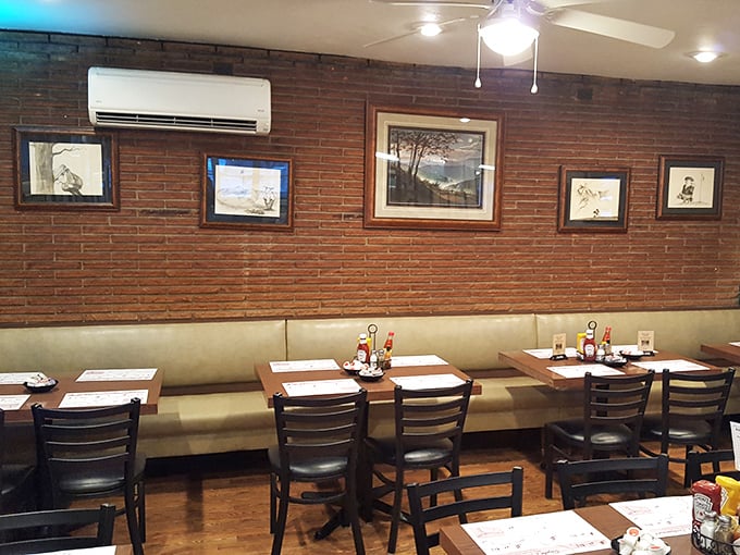 Brick walls, framed landscapes, and comfortable seating create the perfect backdrop for memories made over memorable meals.