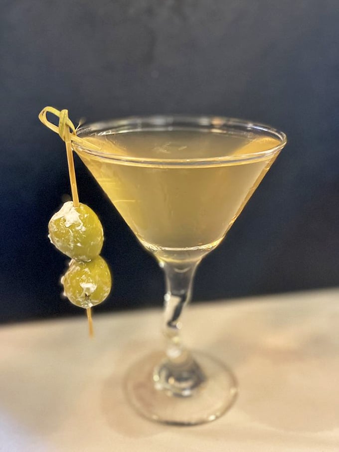 A martini that's dressed better than most people at the party. Those olive garnishes aren't just accessories—they're the perfect punctuation to each sip.