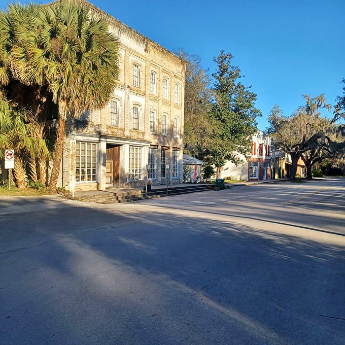 Morning light bathes the historic buildings in golden warmth, highlighting architectural details from an era when craftsmanship mattered.