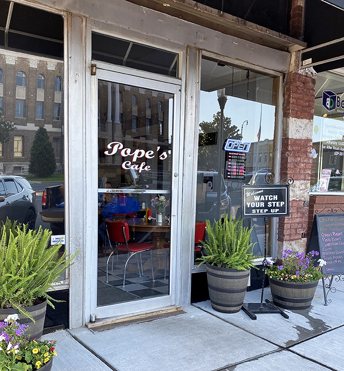Planters flanking the entrance like sentries guarding the gateway to flavor town—a humble doorway that promises more satisfaction than many fancy establishments.