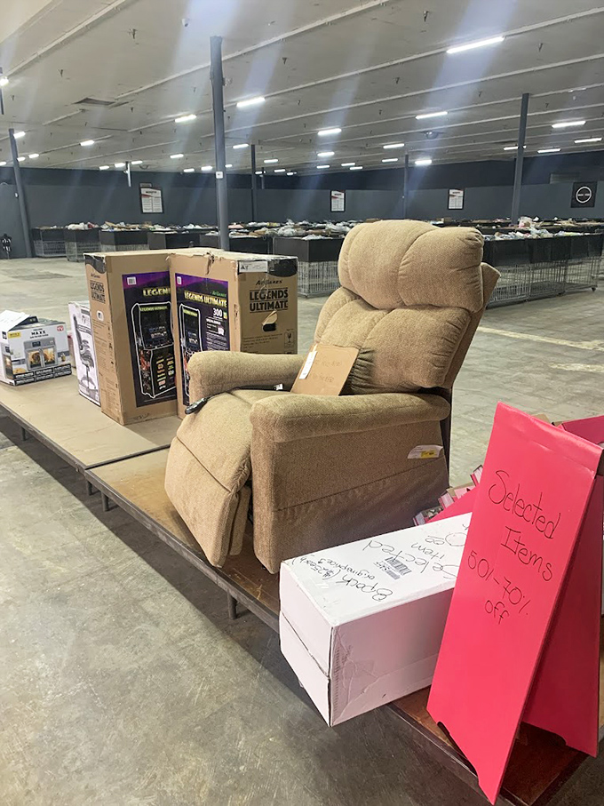 That recliner isn't just furniture—it's a throne awaiting its bargain-hunting royalty, complete with arcade cabinet courtiers.