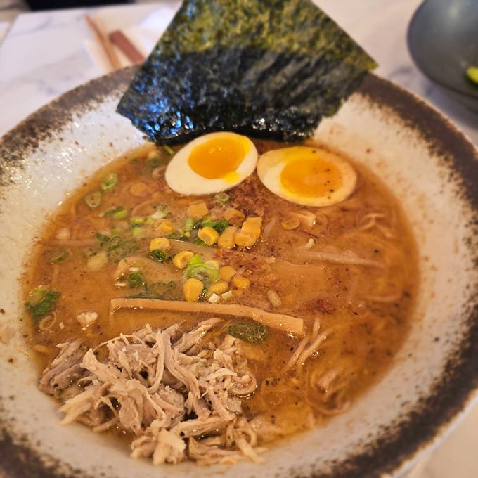 Chicken ramen wearing its corn kernels like tiny yellow jewels – comfort food dressed for a night out.