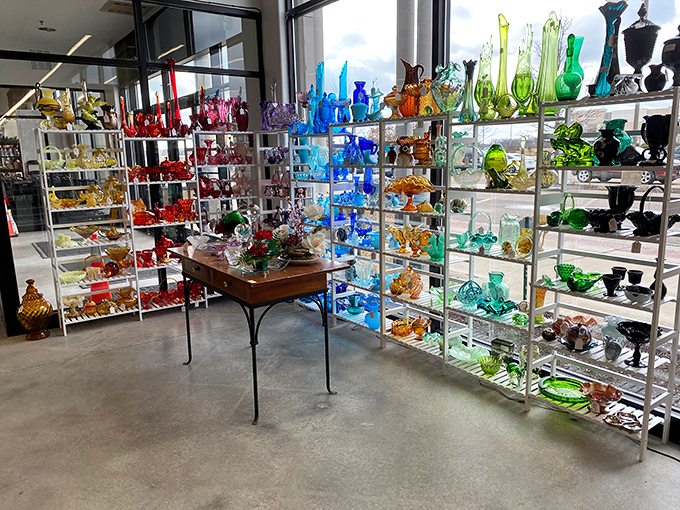 A rainbow of vintage glass catches the light like a disco ball for collectors – organized by color for maximum visual impact.