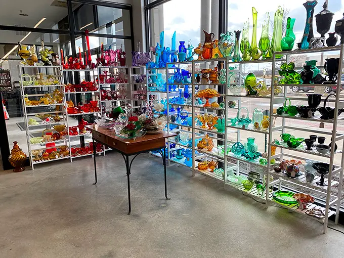 A rainbow of vintage glass catches the light like a disco ball for collectors – organized by color for maximum visual impact.