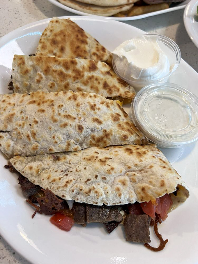 A quesadilla that took a detour through Athens – Mediterranean meets Mexican in this cross-cultural flavor festival.