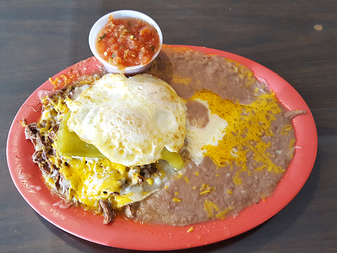 Huevos Rancheros that could fuel a marathon—sunny eggs perched atop a landscape of beans, cheese, and tortillas like edible mountain peaks.