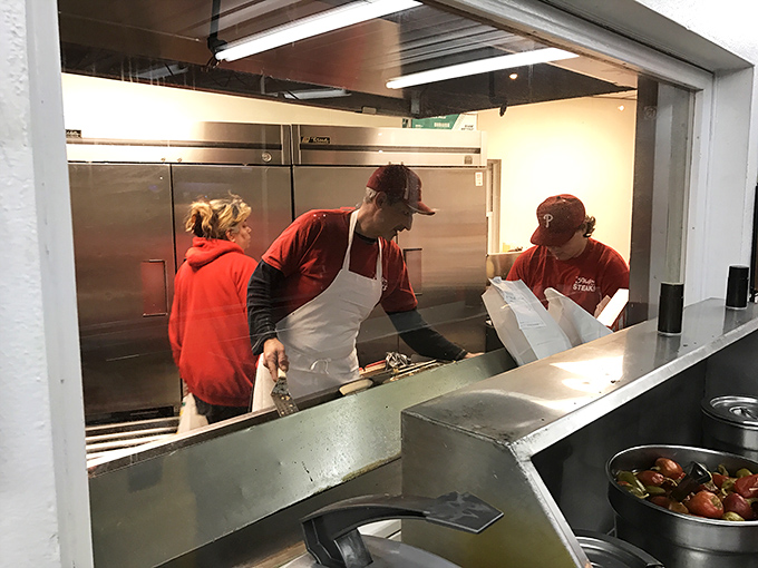 Behind the scenes, where sandwich dreams become reality. The kitchen crew works their magic with practiced precision.