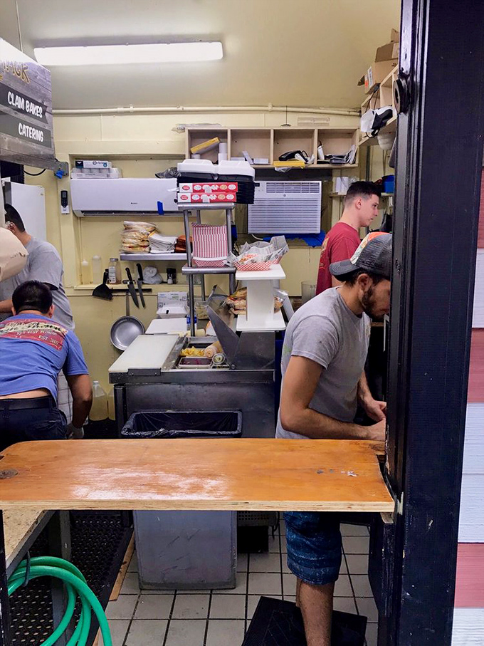 The kitchen ballet—where seafood magic happens in a space smaller than most walk-in closets.