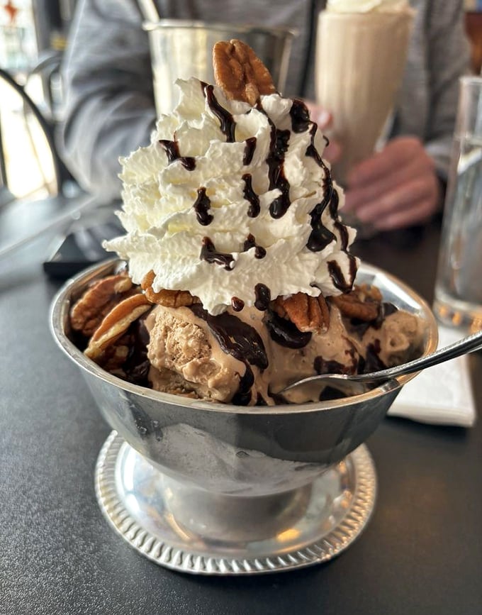 Ice cream elevated to architectural wonder. This sundae doesn't just satisfy cravings—it creates memories topped with whipped cream mountains and chocolate rivers.