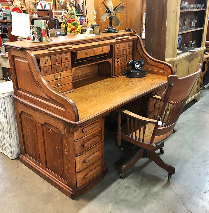 This isn't just a desk—it's command central for the 1920s professional. More drawers than a department store and twice the character.