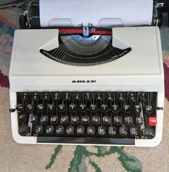 An Adler typewriter waiting for its second act—perhaps as the start of your novel or just the coolest Zoom call background ever.