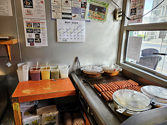 Hot dogs lined up like soldiers ready for duty. The condiment station stands prepared for whatever delicious battle you're planning.