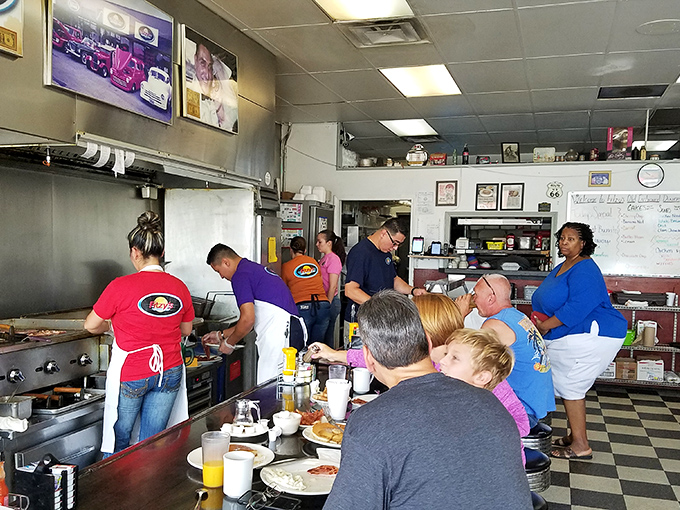 An open kitchen where breakfast ballet happens—cooks pirouetting between orders while counter-seated guests get dinner and a show.