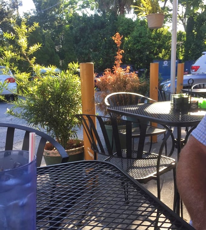Outdoor seating surrounded by greenery offers the perfect Florida breakfast experience: sunshine, fresh air, and the promise of something delicious.