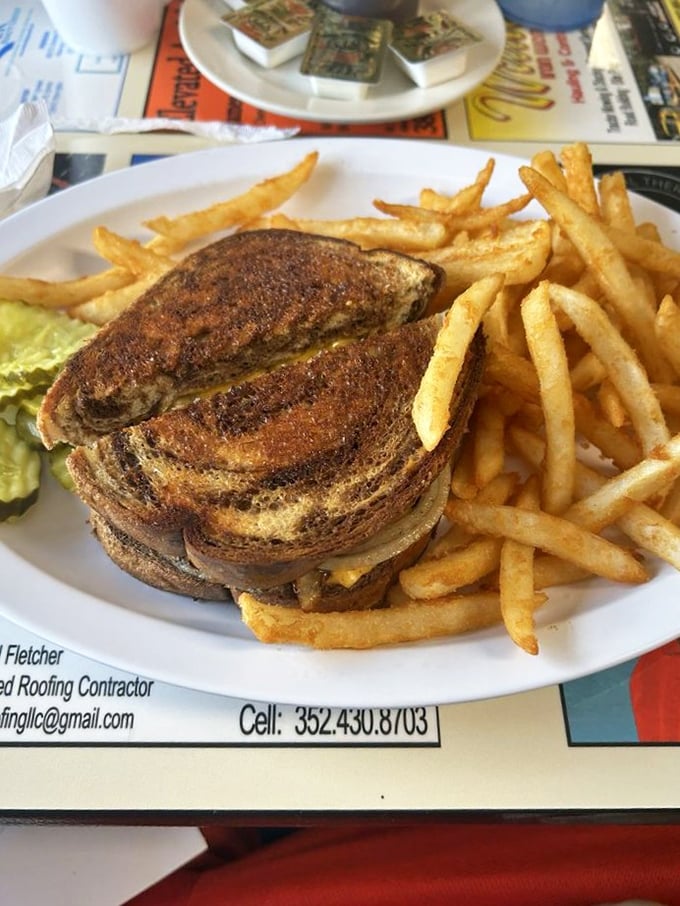 The perfect patty melt reveals itself: grilled rye bread embracing melted cheese and beef in a sandwich that's worth every napkin you'll need.