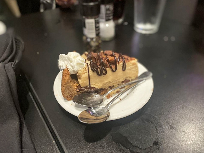 The peanut butter pie finale—where chocolate drizzle meets whipped cream in a dessert so good you'll contemplate ordering a second slice.