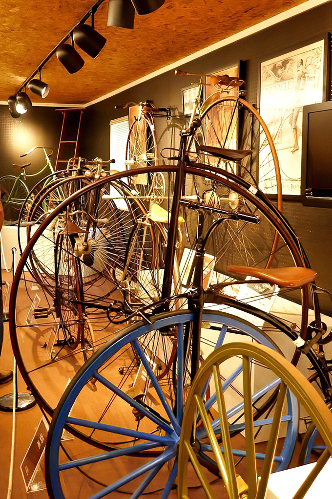 Penny-farthings cluster like mechanical giraffes. These high-wheelers weren't just transportation—they were daredevil status symbols for the Victorian influencer.