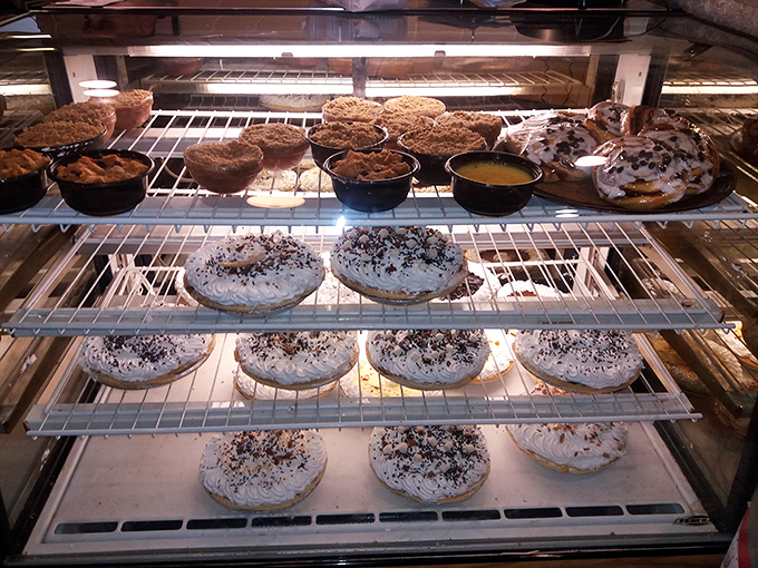 The dessert case—where diet plans go to die and happiness is measured in layers of cream, fruit, and perfectly flaky crust.