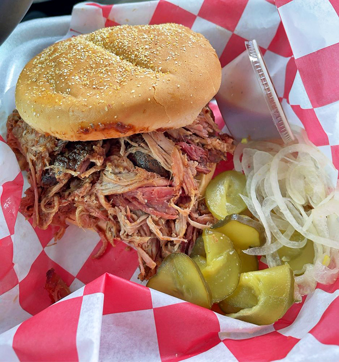 This pulled pork sandwich isn't just a meal—it's an achievement. The pickles and onions add the perfect tangy contrast to the smoky meat.