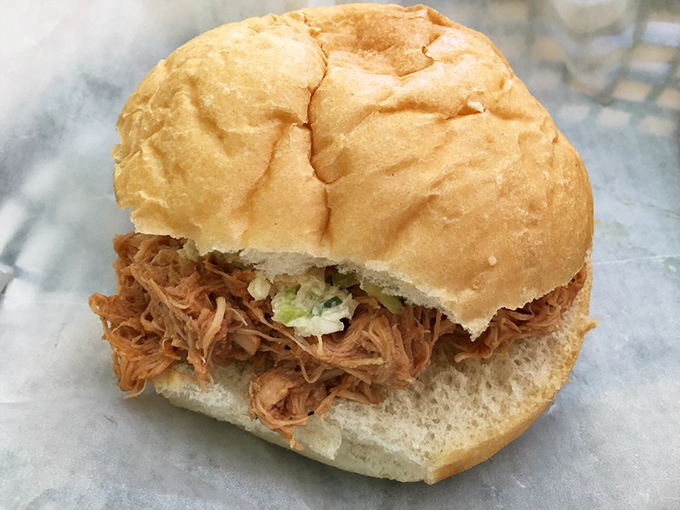 BBQ pulled chicken on a soft bun—proof that sometimes the messiest foods are the ones most worth the napkin investment. 