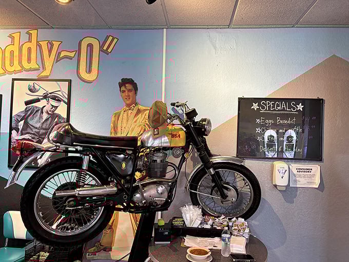 That vintage motorcycle and Elvis poster aren't just decoration—they're time travel companions while you wait for your pancakes. Rock and roll meets over-easy.