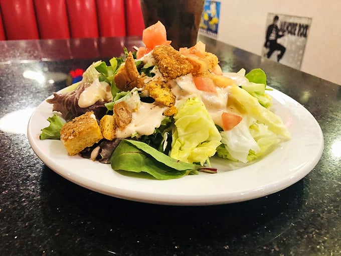 Even the salad looks happy to be here. Those croutons aren't just for crunch—they're little flavor lifeboats in a sea of fresh greens.