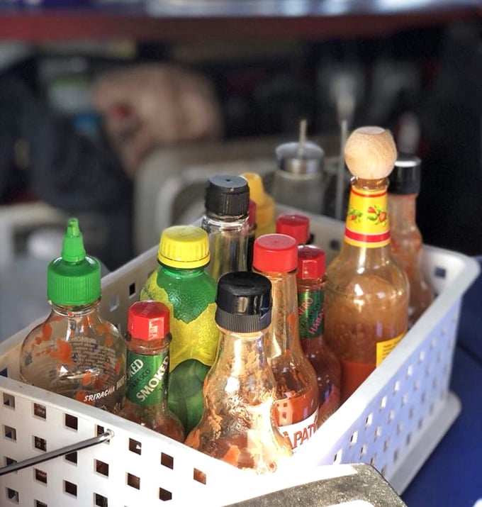 The condiment collection – where flavor adventures begin. These bottles hold the secret weapons that allow each diner to customize their maritime feast.
