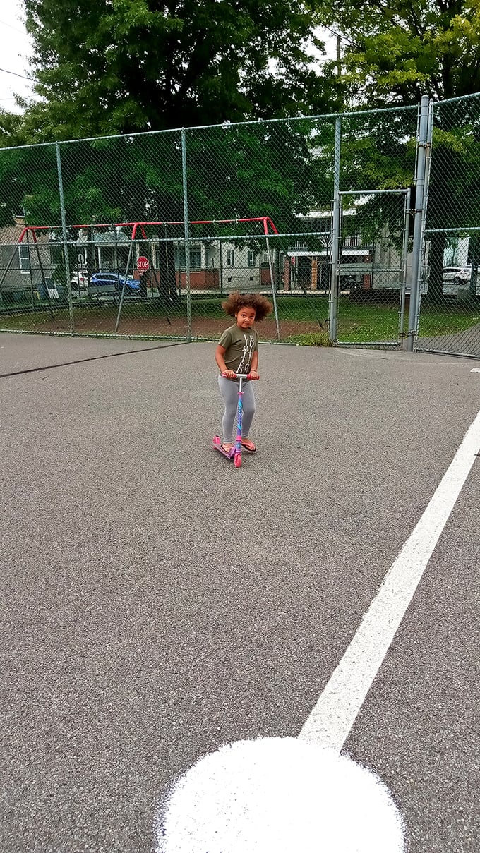 Childhood joy on a scooter – some pleasures remain timeless. Community playgrounds create memories that last longer than any smartphone game.