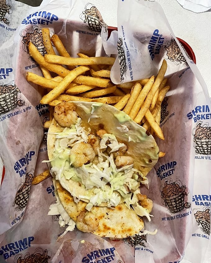 A shrimp taco that understands balance – warm tortilla, crisp lettuce, perfectly cooked shrimp, and fries that refuse to be mere sidekicks.