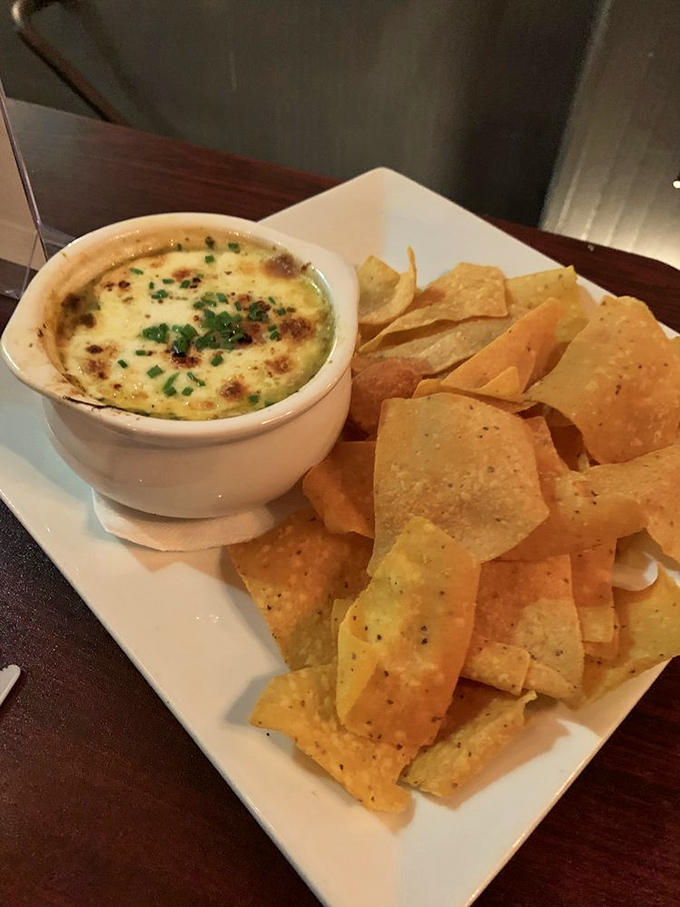 Spinach artichoke dip that achieves the perfect molten-to-crisp ratio. Those house-made tortilla chips aren't just dippers—they're edible spoons for liquid gold.