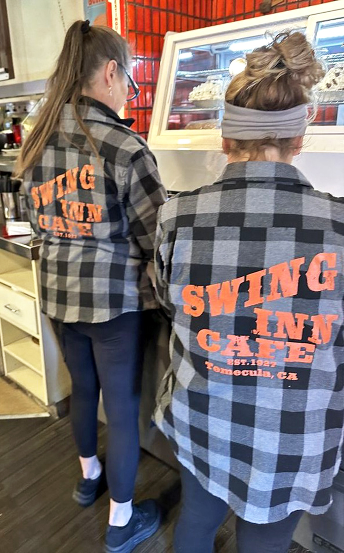 The plaid-clad staff sporting their Swing Inn pride—these folks aren't just servers, they're keepers of the flame.