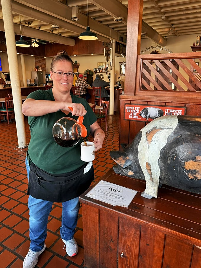 Fresh coffee being poured alongside a whimsical pig statue—because the best diners always mix hospitality with a dash of quirky personality.