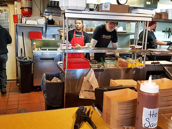 The magic happens behind this counter, where pit masters orchestrate a symphony of smoke and meat with practiced precision.