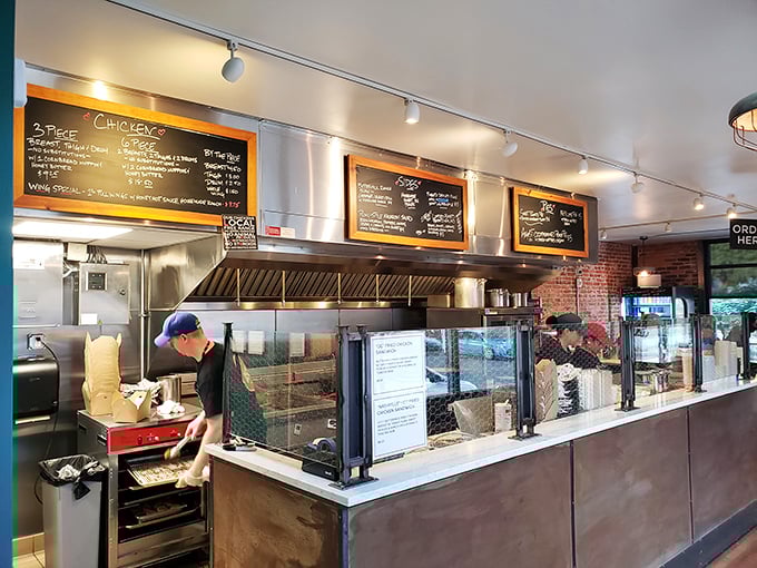 Behind the counter, focused staff orchestrate the delicate dance between raw ingredients and golden-brown perfection.