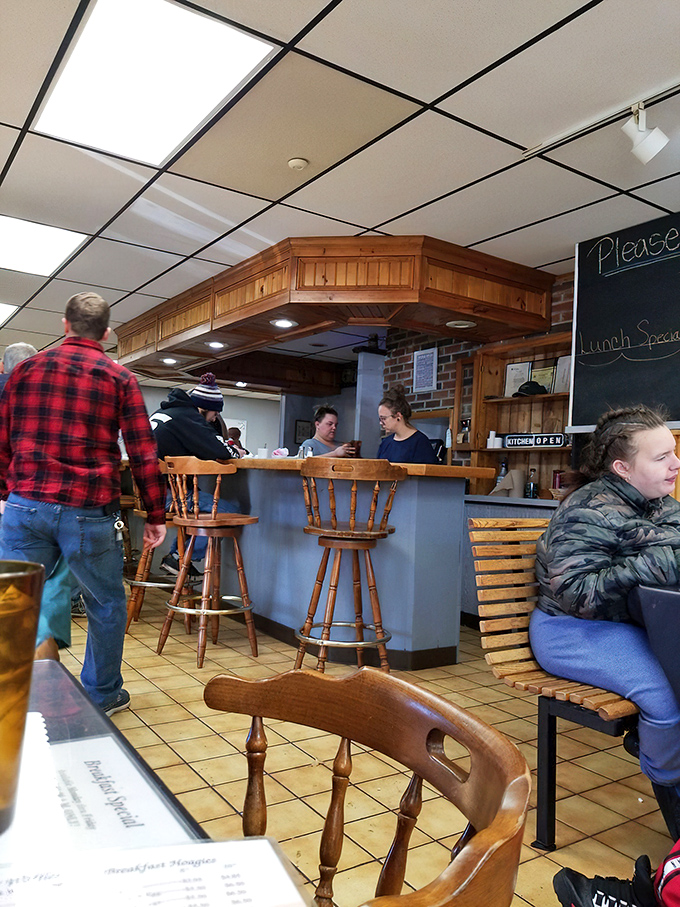 The counter – where breakfast magic happens behind wooden trim and where regulars perch to watch their morning fuel being prepared.