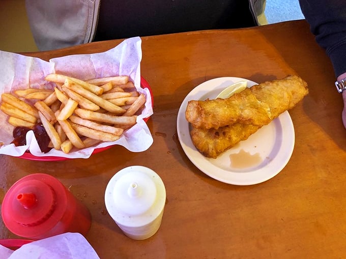 A plate that speaks the universal language of comfort. The fish and fries are having a party, and your taste buds are invited.