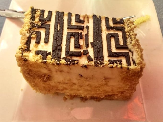 This tiramisu's geometric chocolate design isn't just decoration – it's edible art that's too pretty to eat, but you will anyway.