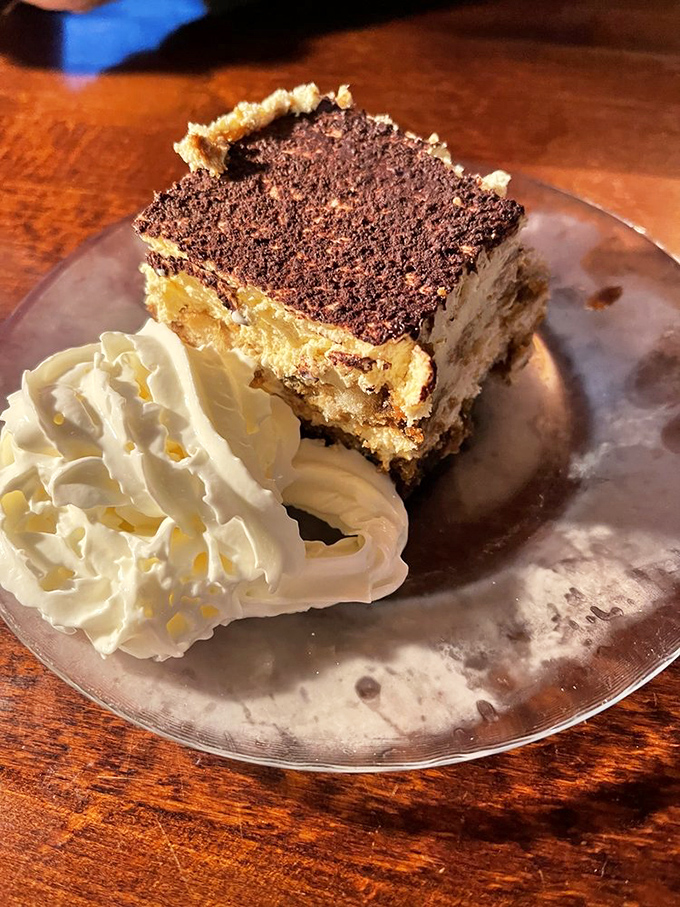 Tiramisu that strikes the perfect balance between coffee, cream, and chocolate—the kind of dessert that makes you consider skipping the main course next time.