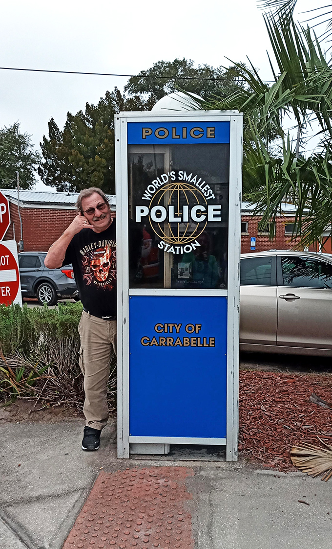 Tourists discover that posing with the world's smallest police station makes for unexpectedly delightful vacation photos.