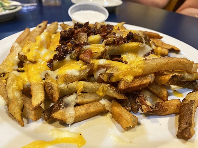 Cheese fries with bacon bits that laugh in the face of diet plans. Some foods are worth every delicious calorie—this is definitely one of them.