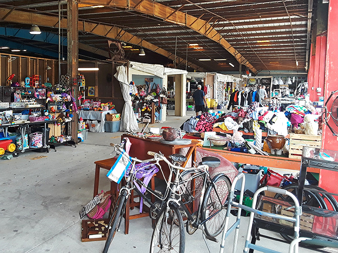 The beautiful chaos of a true flea market aisle – bicycles, furniture, and mystery items that whisper, "You definitely need me in your garage."