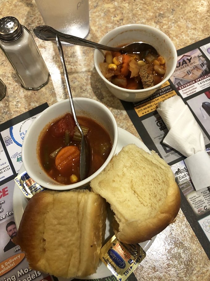Two soups, one mission: to warm your soul. Those dinner rolls aren't just bread—they're edible spoons waiting for their moment to shine.