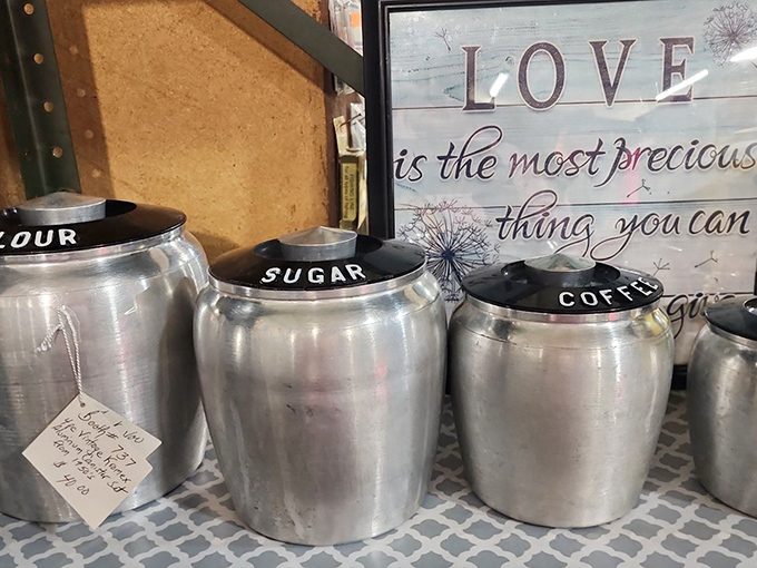 Flour, "Sugar," "Coffee" – these vintage aluminum canisters speak the universal language of grandma's kitchen, where everything had its proper place.