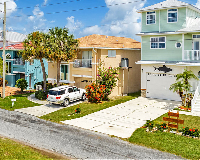 Coastal living in technicolor – homes painted in hues that would make a box of crayons jealous. 